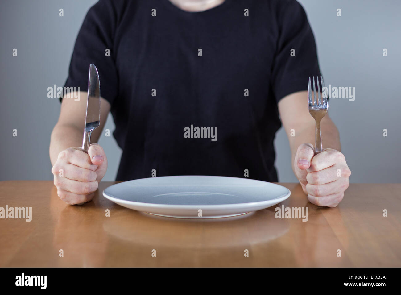 Hungry man empty plate hi-res stock photography and images - Alamy
