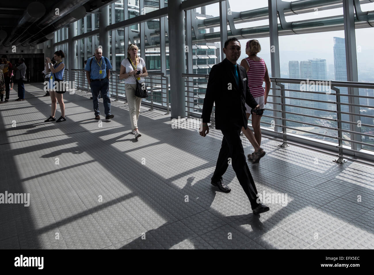 On the bridge between the two towers at the Petronas tower building in ...