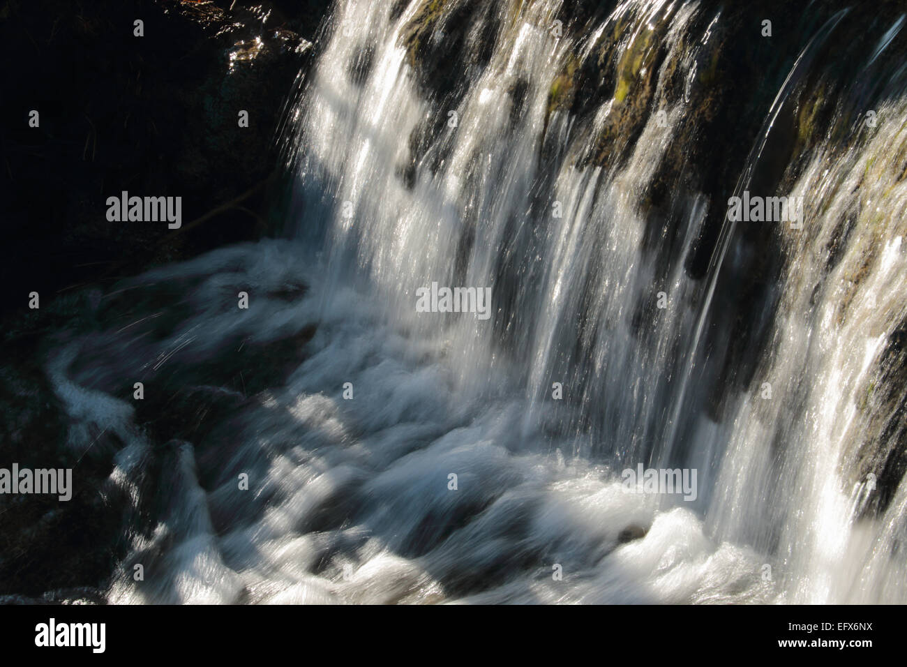 Sparkling stream and waterfall running through village Stock Photo - Alamy
