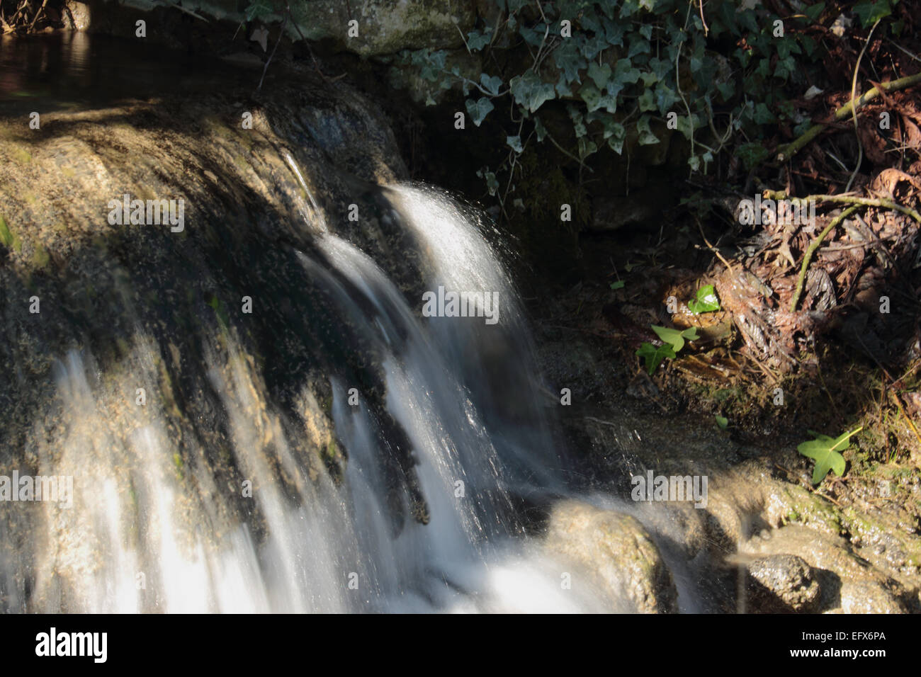 Sparkling stream and waterfall running through village Stock Photo - Alamy