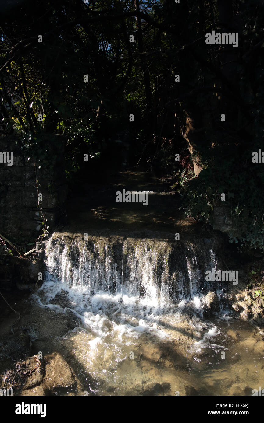 Sparkling stream and waterfall running through village Stock Photo - Alamy