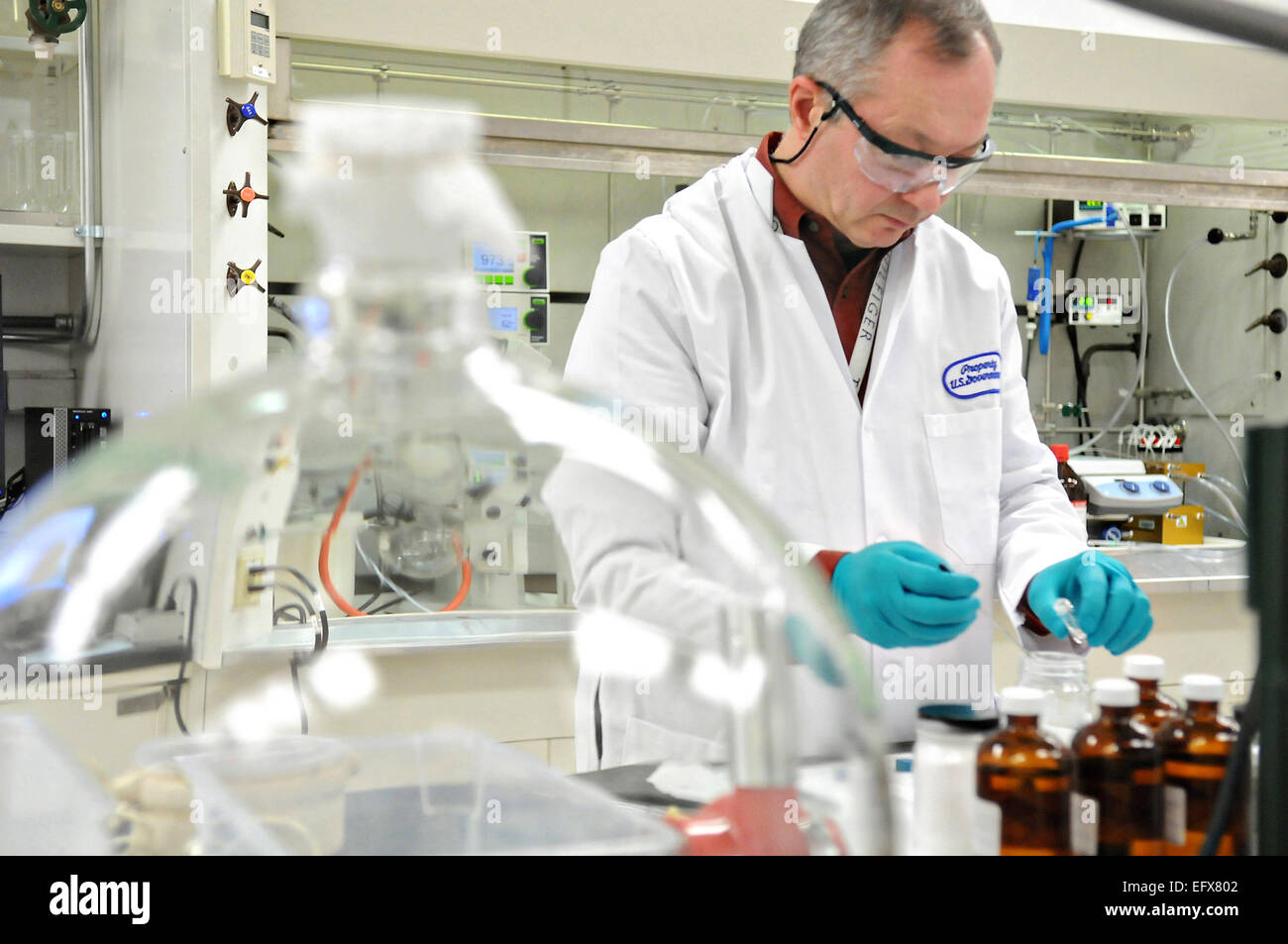 Argonne process R&D chemist Kris Pupek takes quality control samples ...