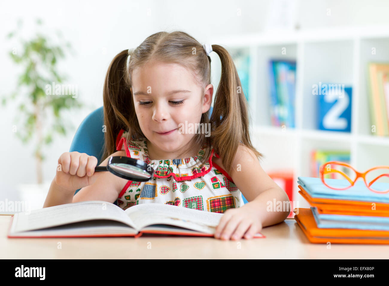 Nursery school children looking books hi-res stock photography and ...