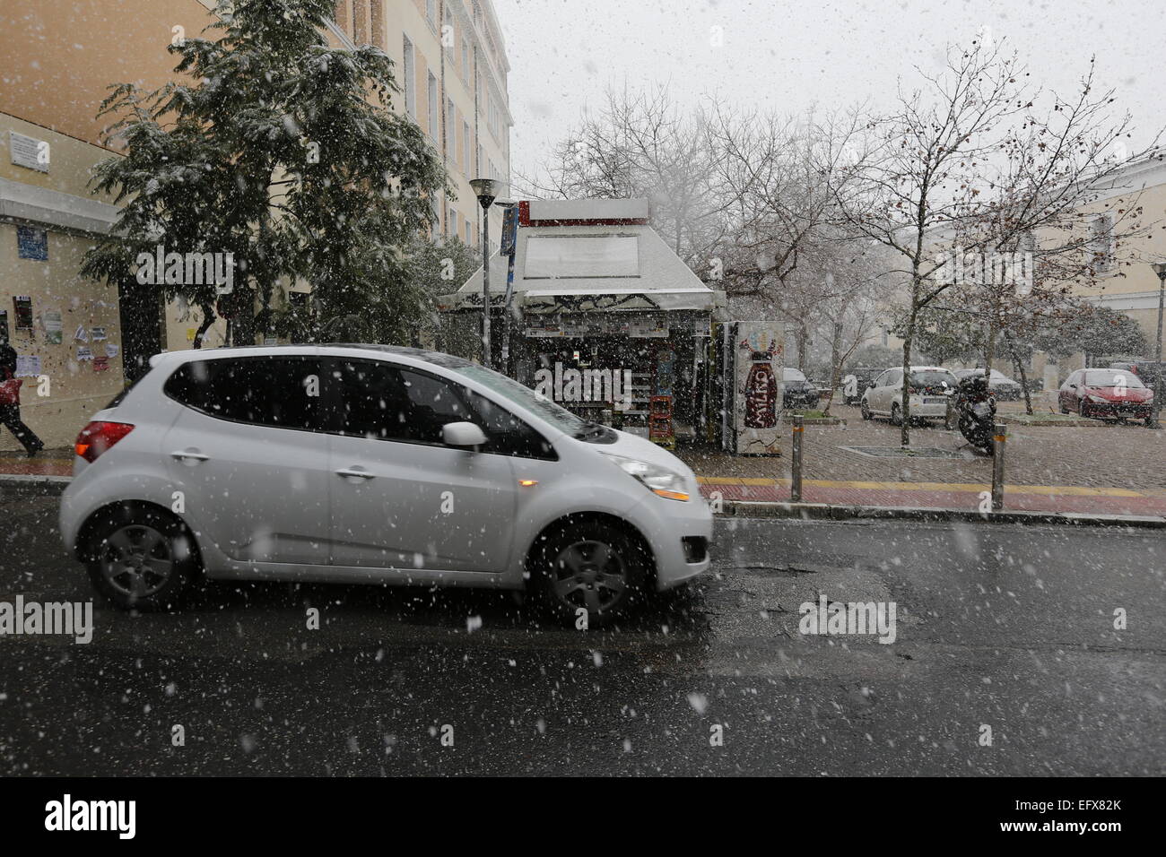 Athens, Greece. 11th February 2015. A car drives through the snowfall ...