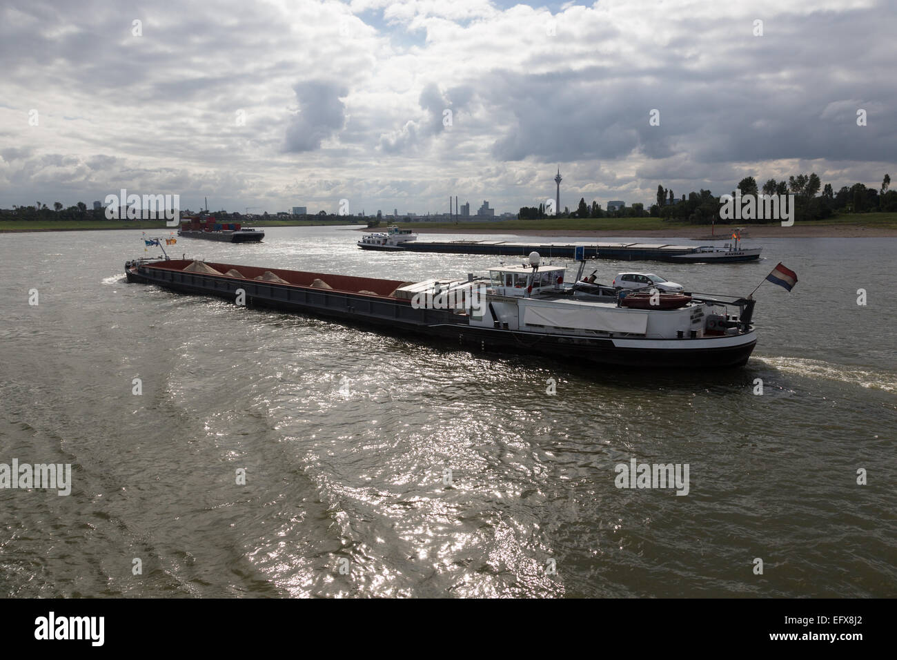 Heavy barge traffic along the Rhine river near Düsseldorf, Germany ...