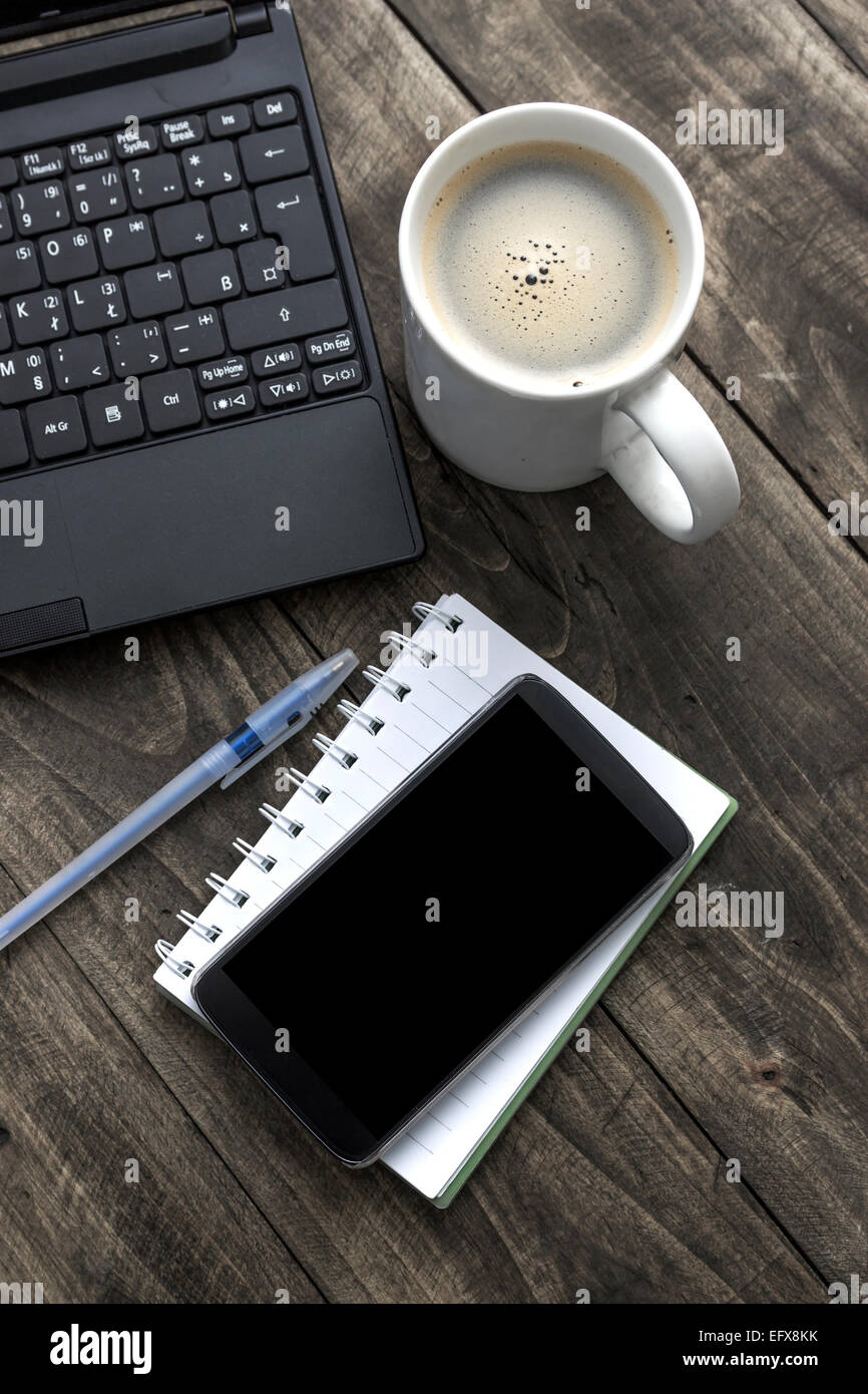 Office desktop with coffee, notepad and laptop. From above Stock Photo ...