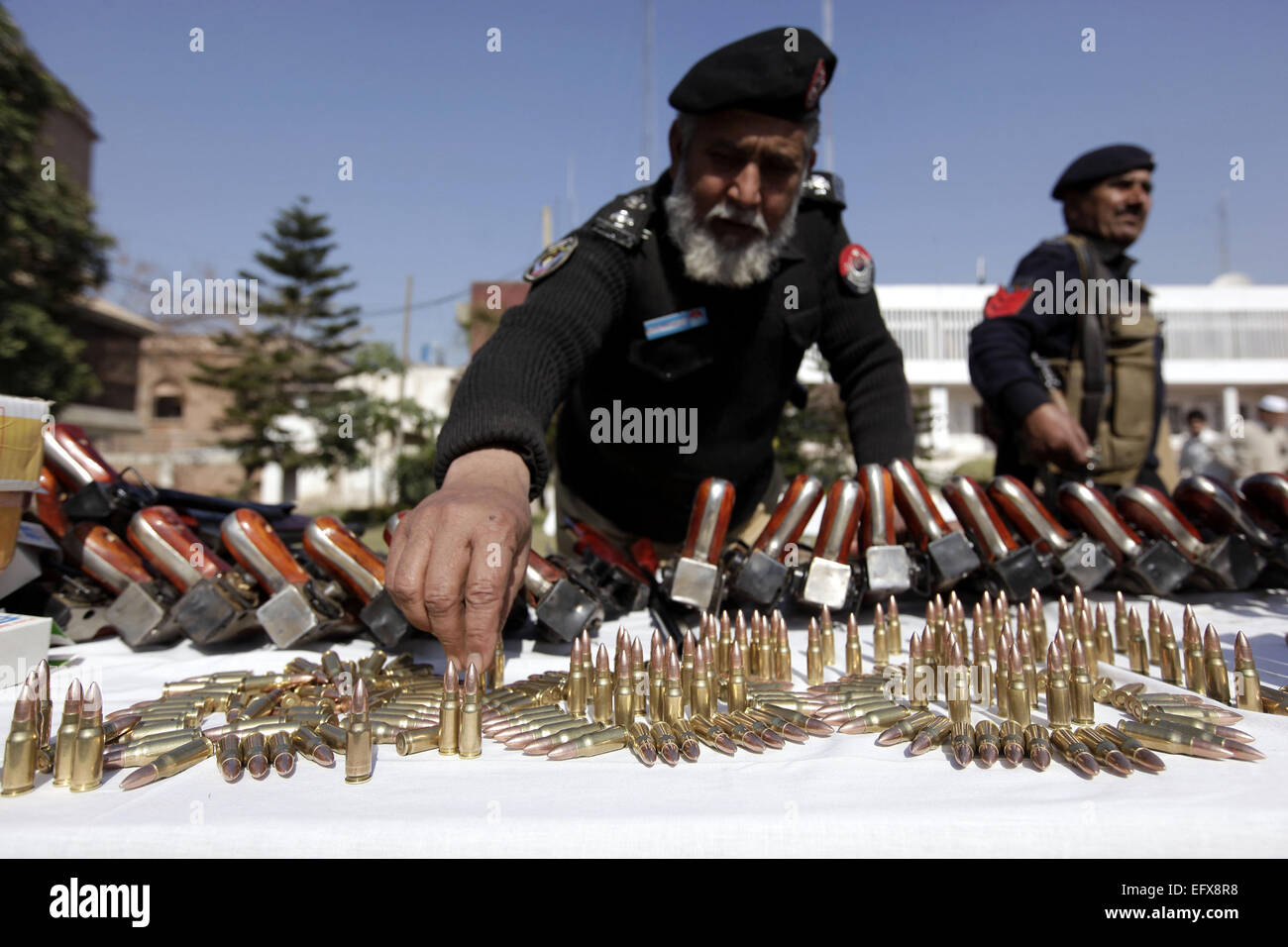 Peshawar. 11th Feb, 2015. A Pakistani policeman displays arms and ...