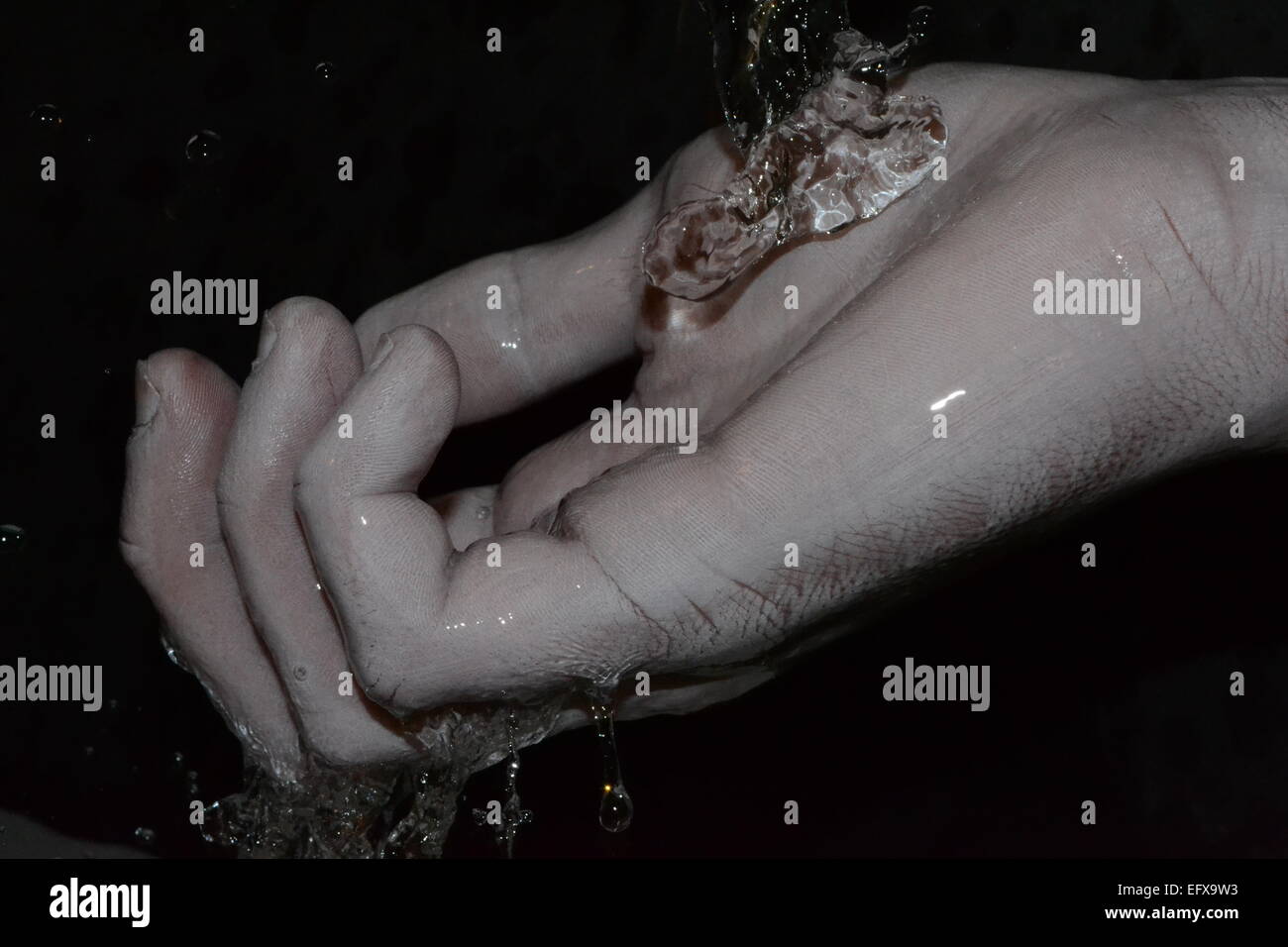 hand holding water, slow motion, white hand black background Stock ...