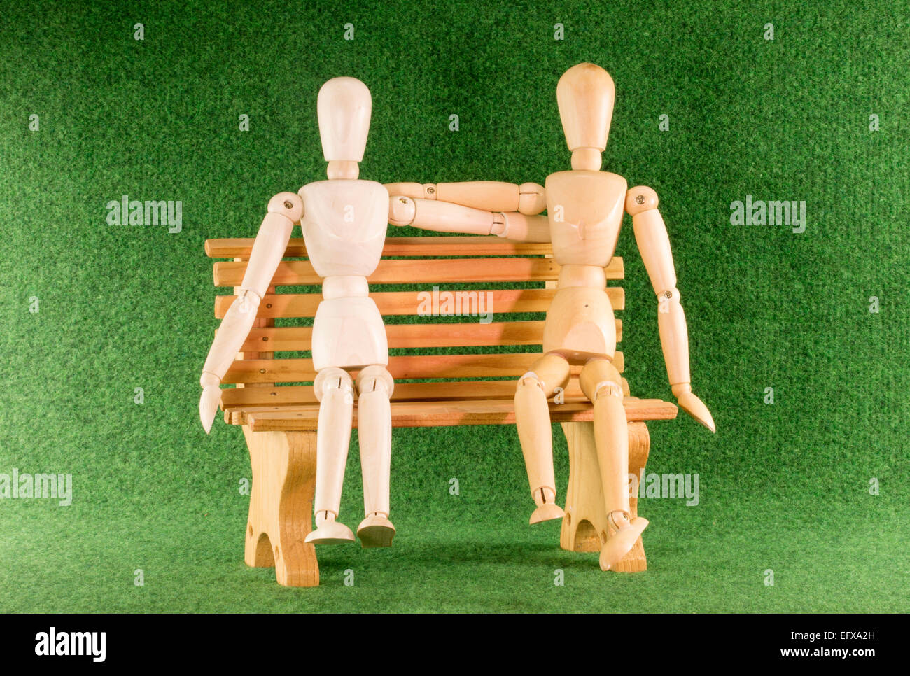 two wooden puppet toys as love couple on bench Stock Photo - Alamy