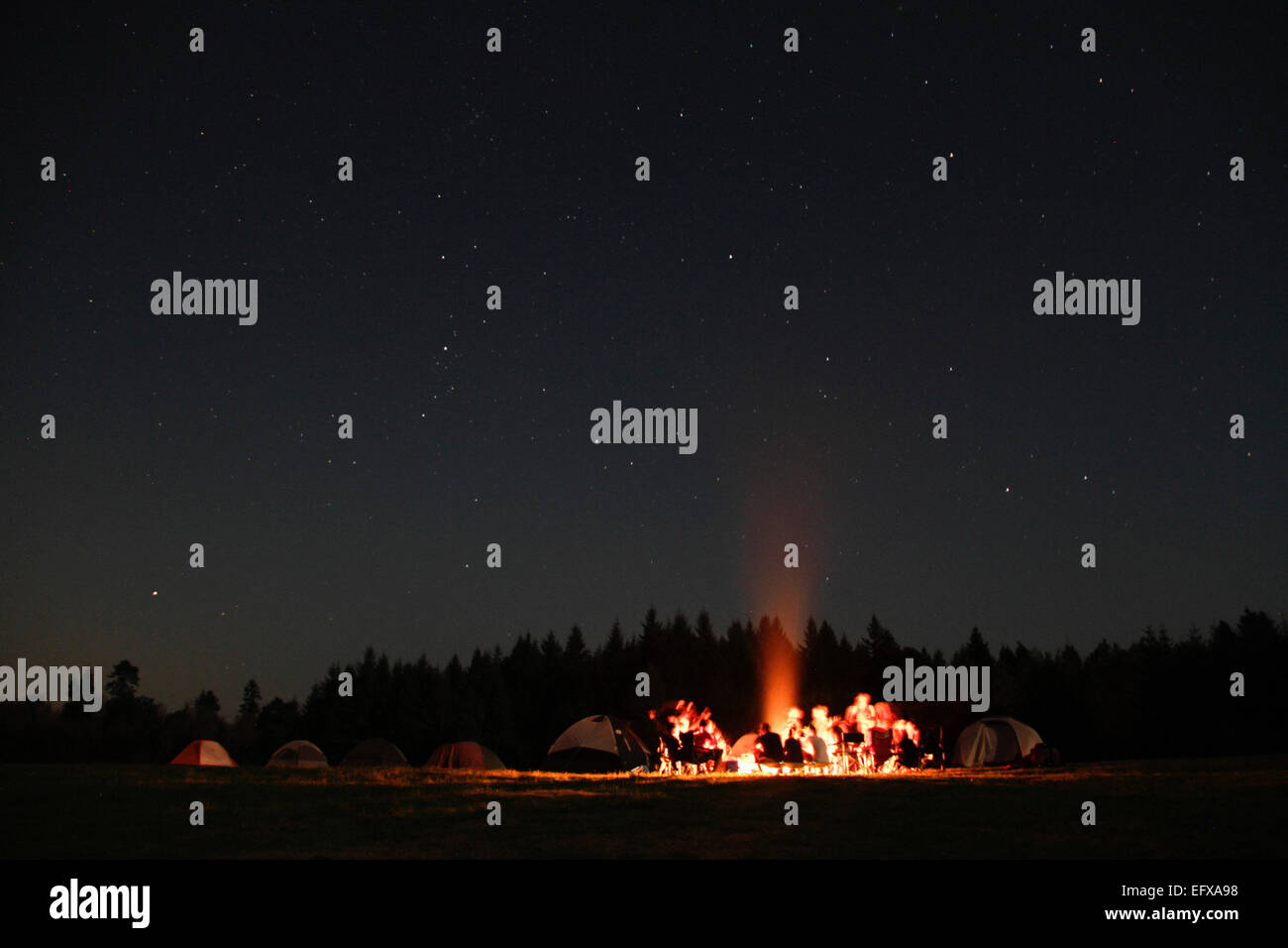 People sitting around campfire night hi-res stock photography and ...