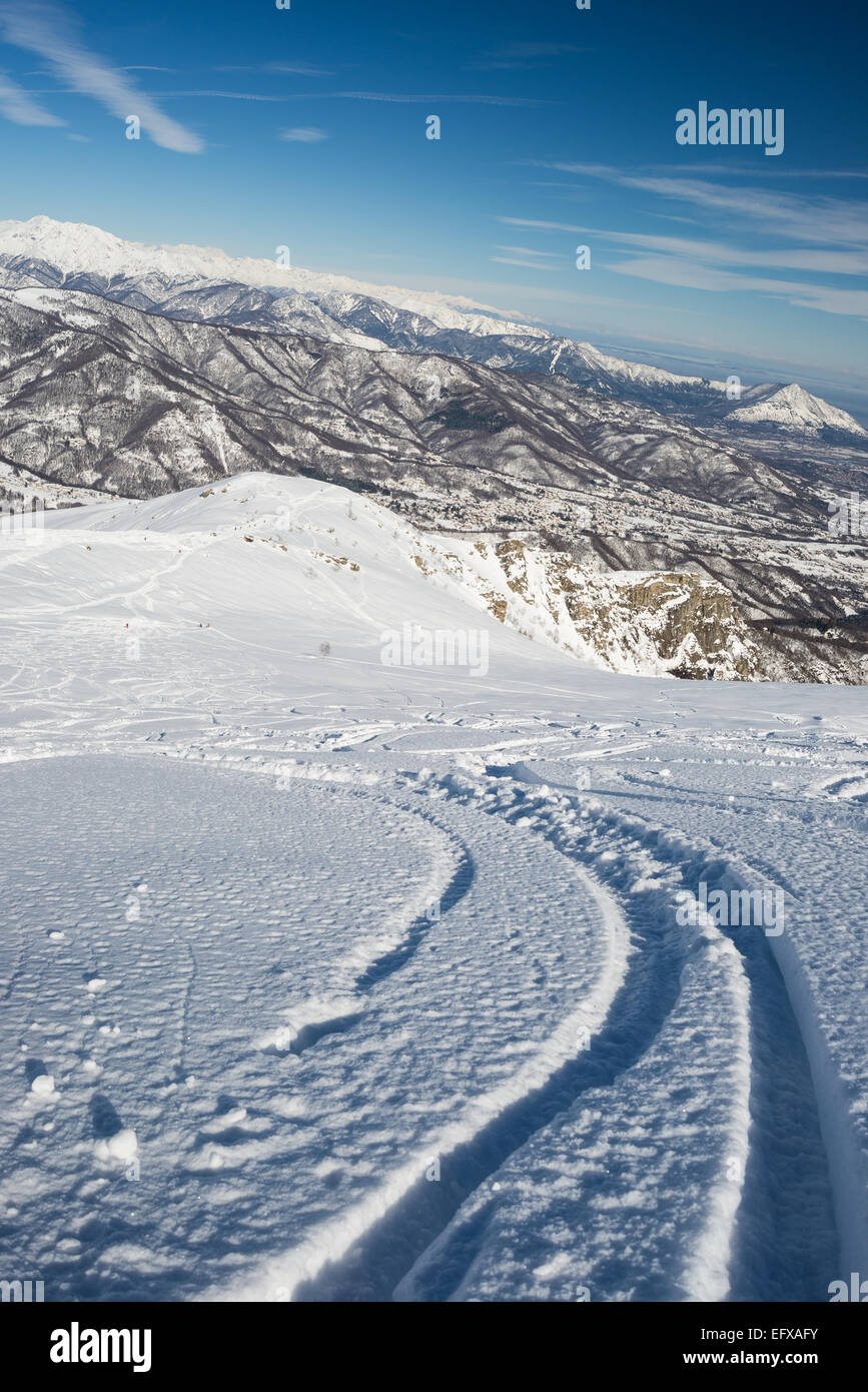 Free ride ski tracks on snowy slope. Oblique shot taken from above in ...
