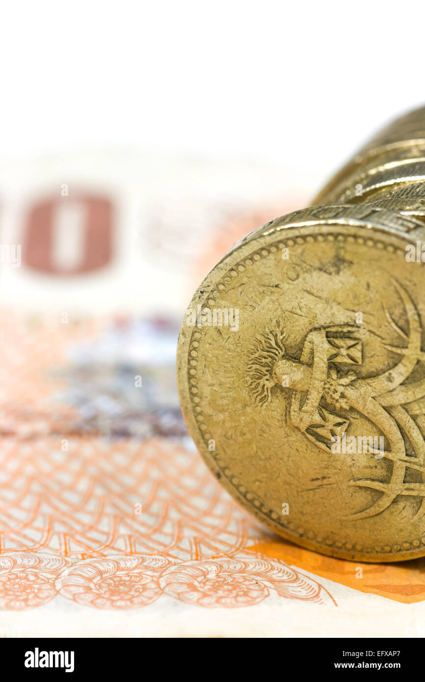 One pound coins on the edge on a white background Stock Photo - Alamy