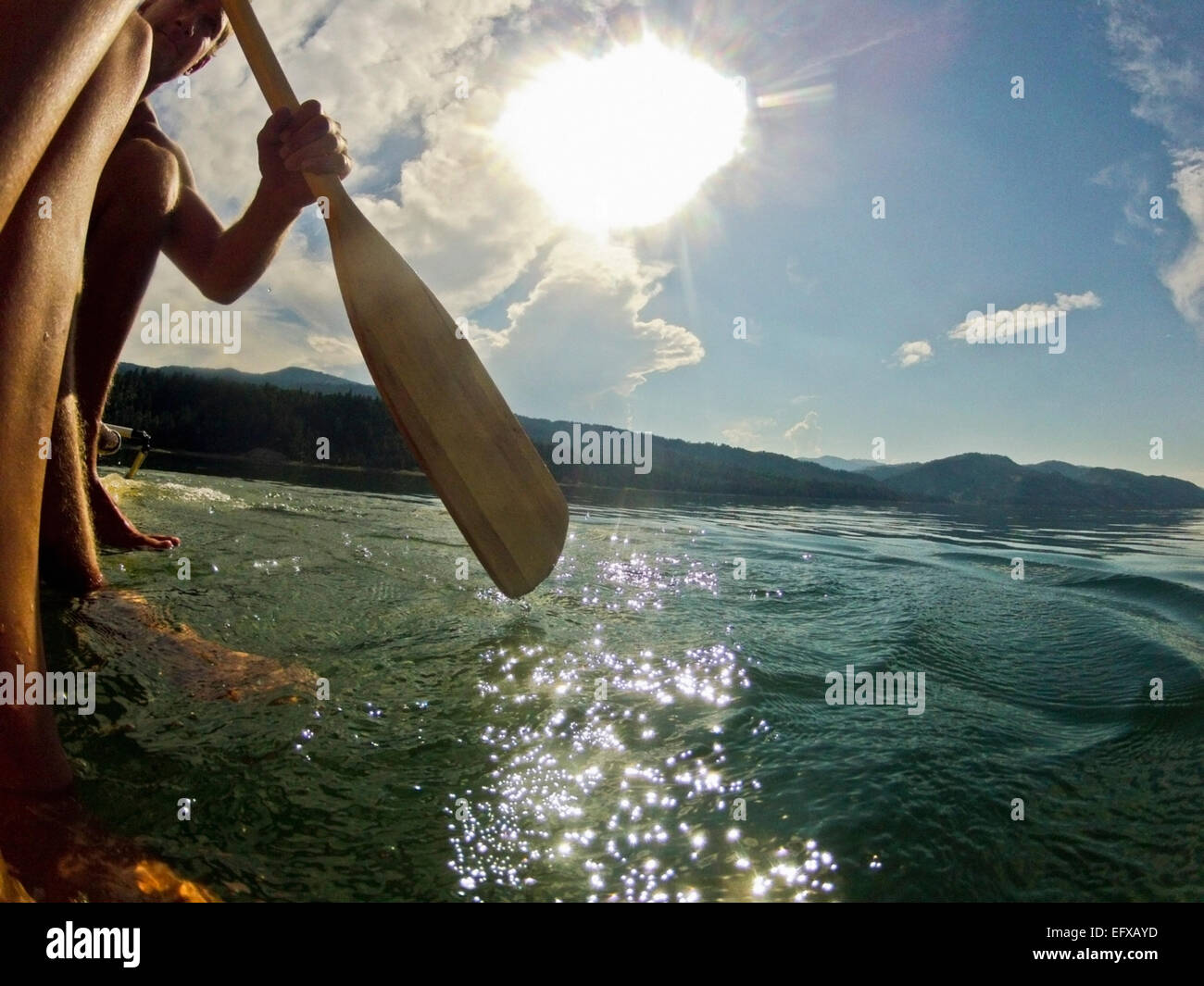 Close up of two young men rowing boat on lake, Mount Hood, Oregon, USA ...