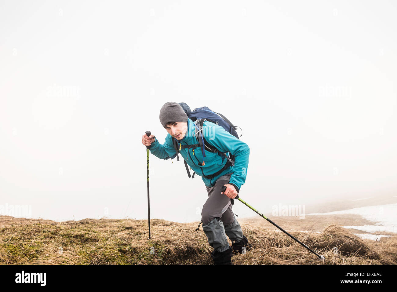 Young male mountain trekker in mist, Bavarian Alps, Oberstdorf, Bavaria ...