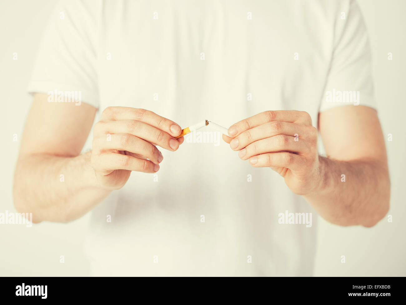 man breaking the cigarette with hands Stock Photo - Alamy