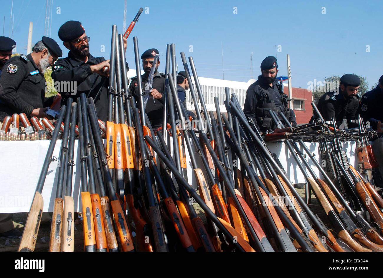 Police officials show seized weapons that were recovered from criminals ...