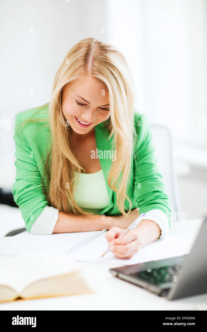smiling student girl writing in notebook Stock Photo - Alamy