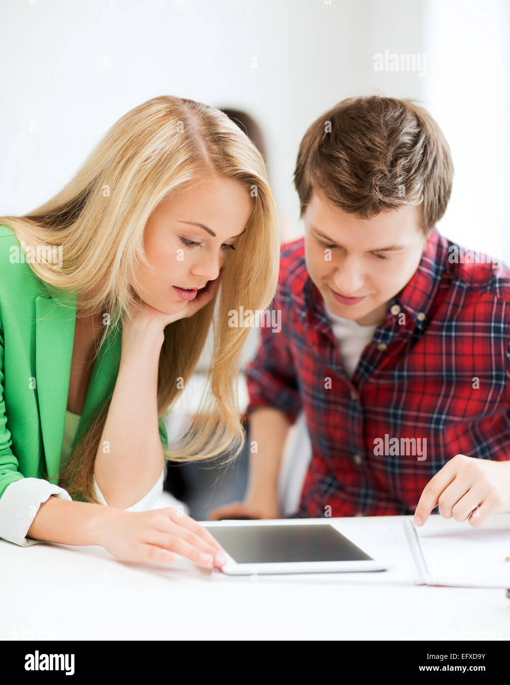 students looking at tablet pc at school Stock Photo - Alamy
