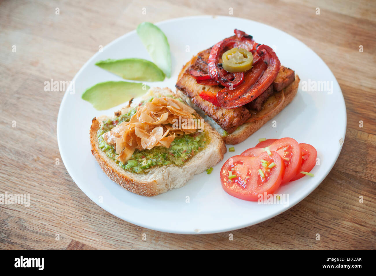 Vegan open faced sandwich with fried tofu, bell peppers and jalapeños ...
