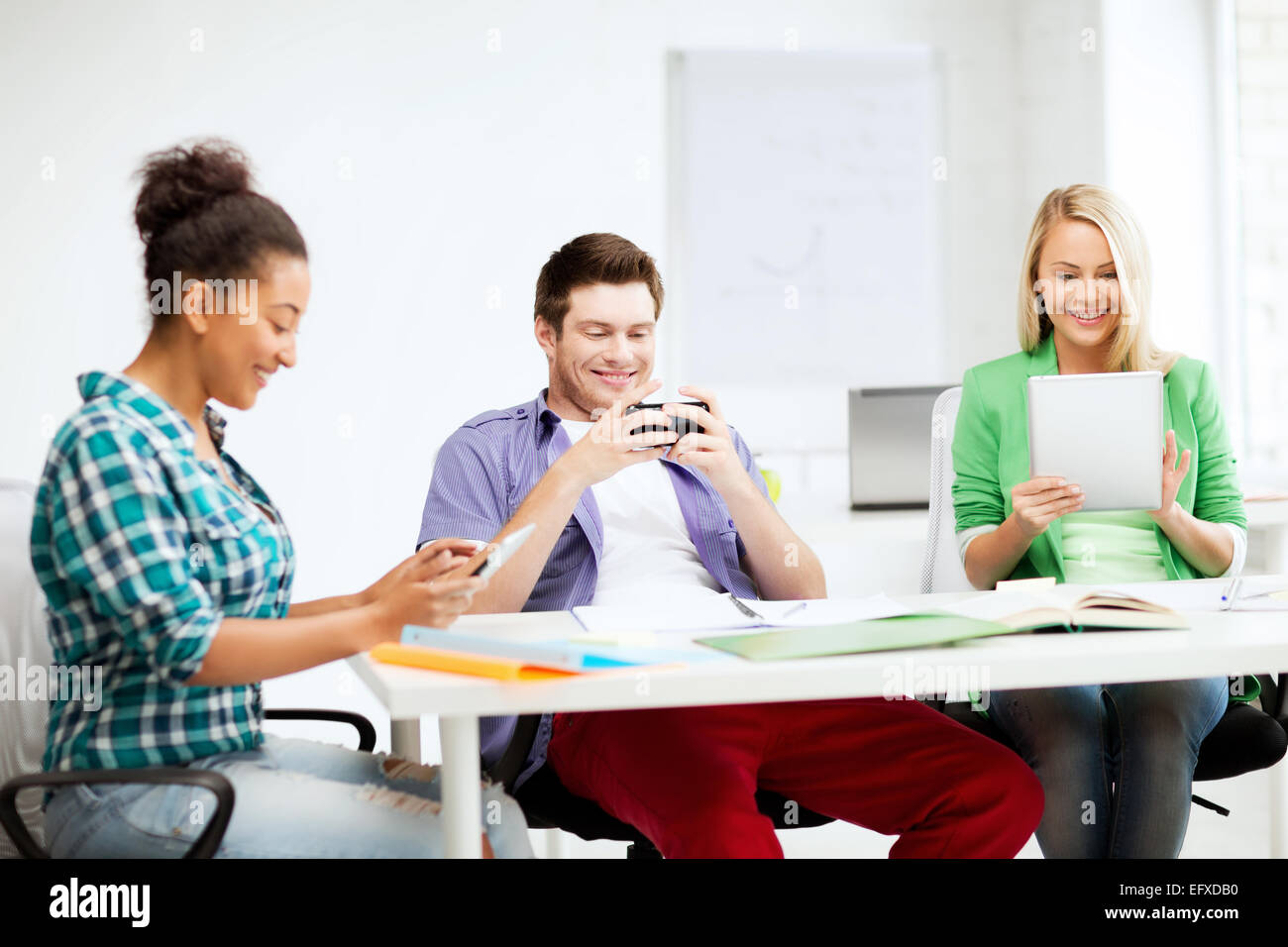 students looking into devices at school Stock Photo - Alamy