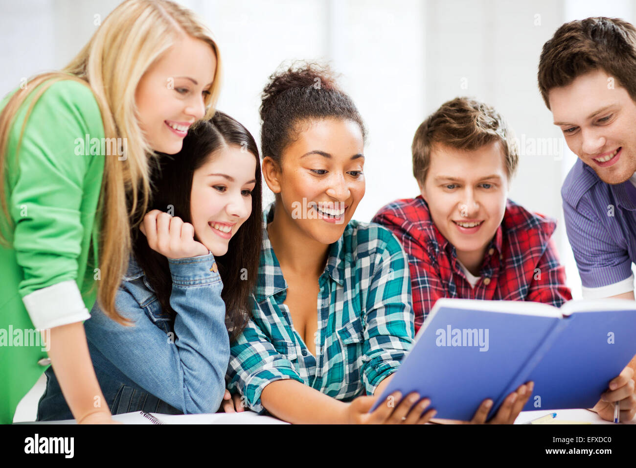 students reading book at school Stock Photo - Alamy