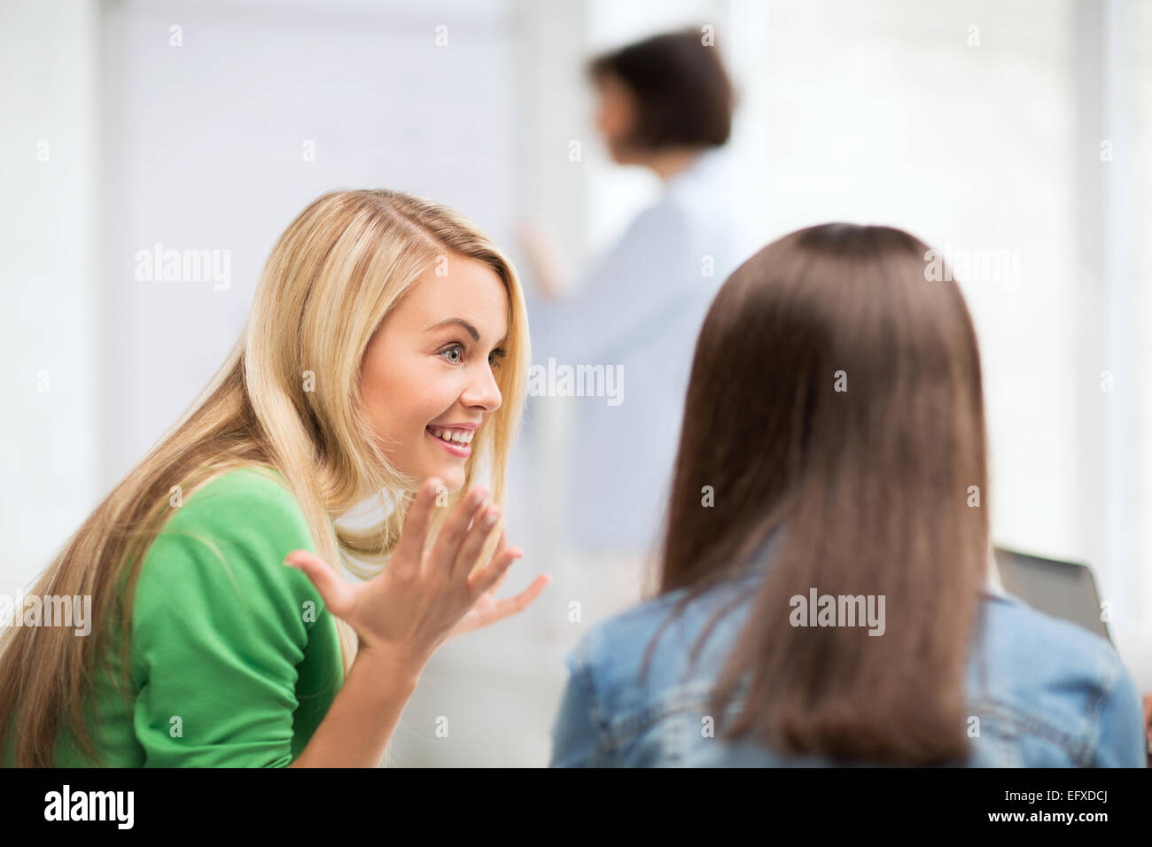 student girl gossiping in lecture at school Stock Photo - Alamy