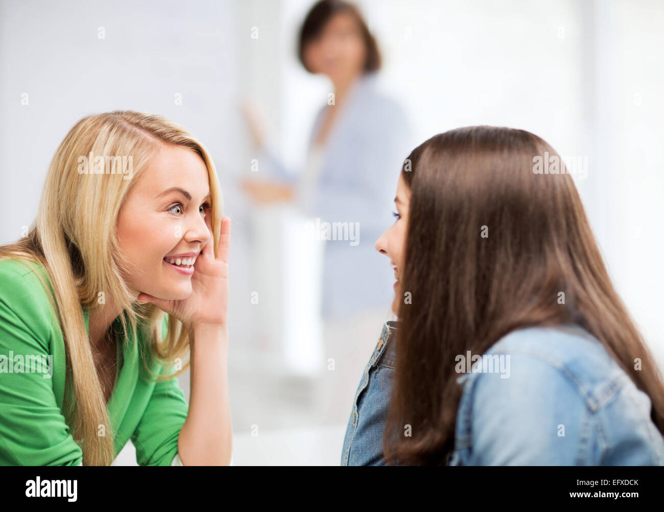 student girls gossiping at school Stock Photo - Alamy