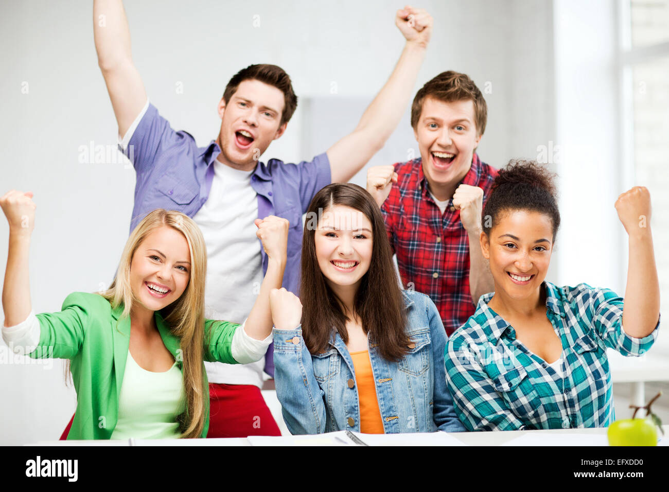 students holding hands up at school Stock Photo - Alamy