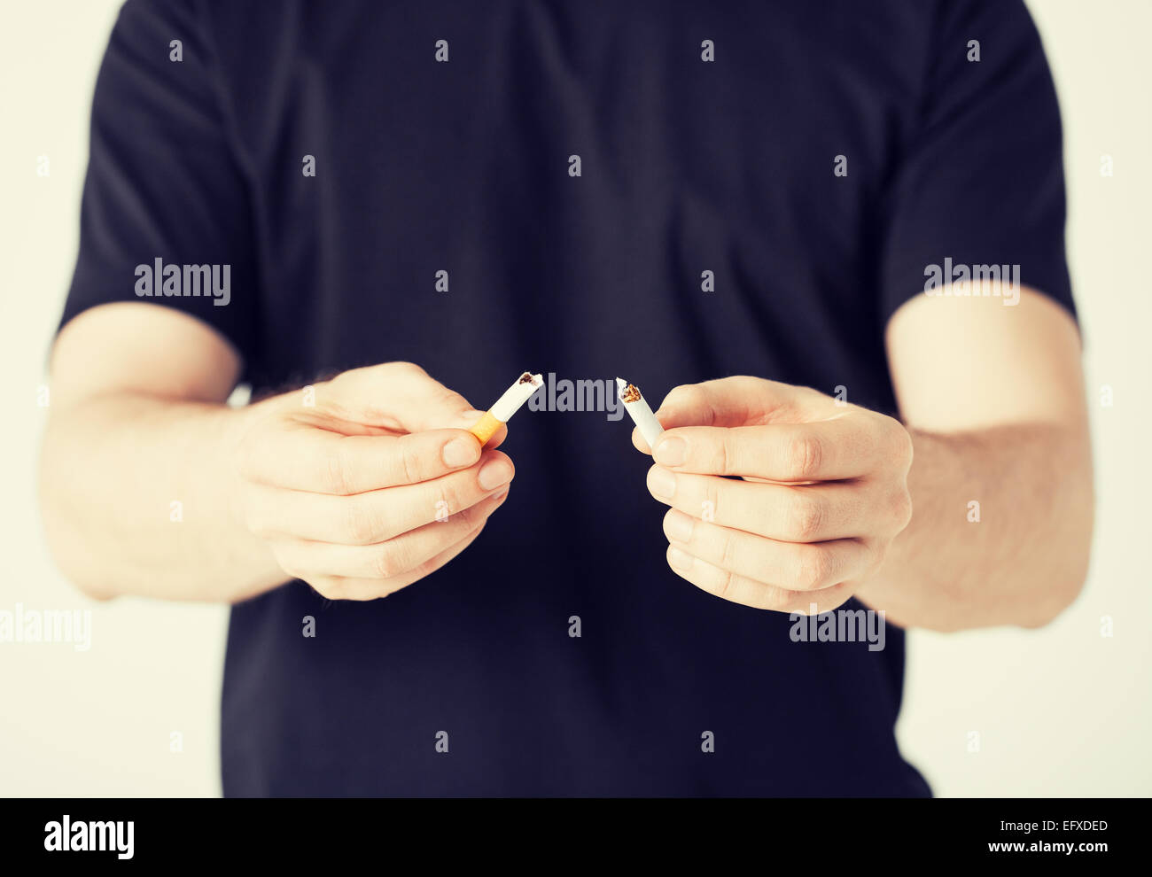 man breaking the cigarette with hands Stock Photo - Alamy