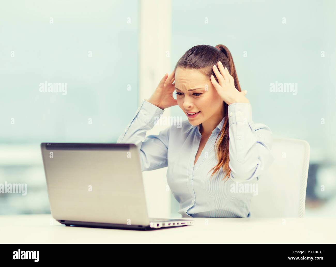 stressed woman with laptop Stock Photo - Alamy