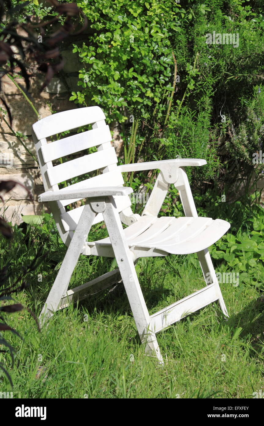 Garden chair on a green grass background Stock Photo - Alamy