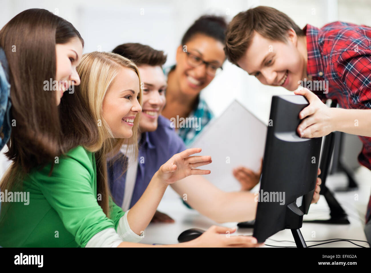 students looking at computer monitor at school Stock Photo - Alamy