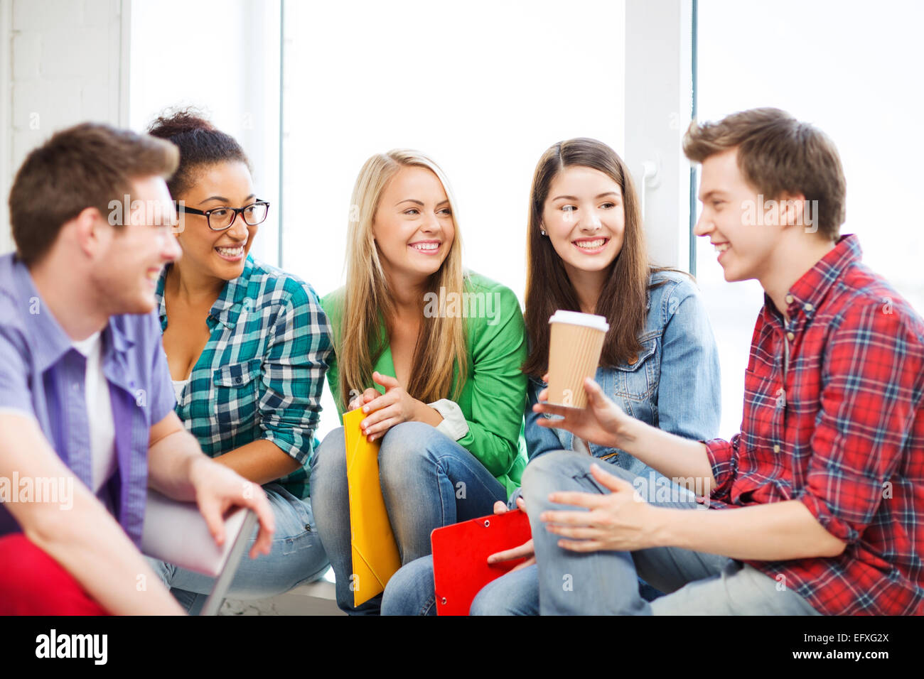 students communicating and laughing at school Stock Photo - Alamy