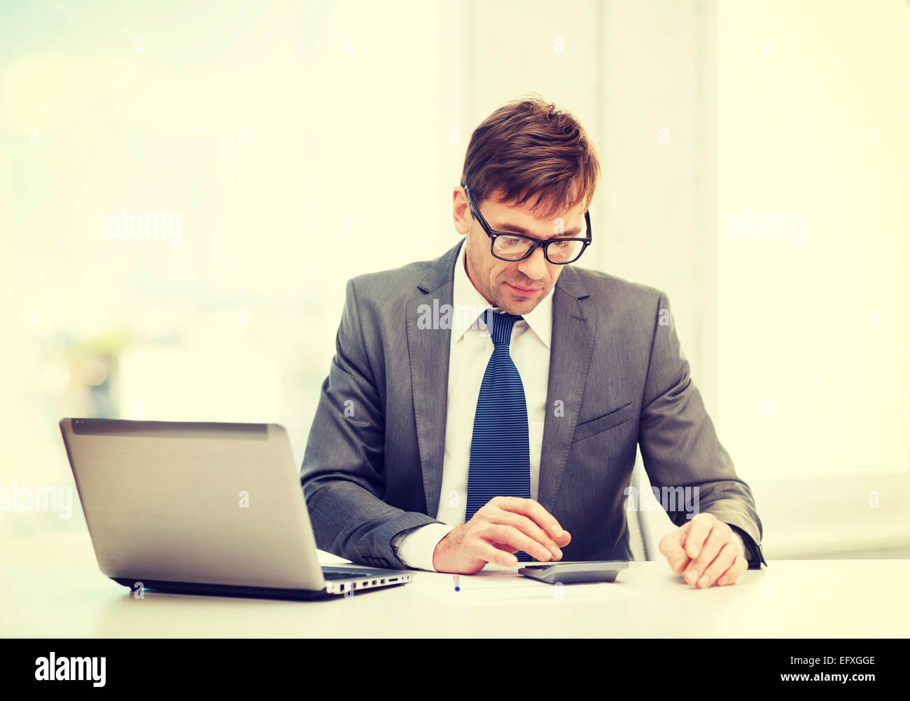 businessman with computer, papers and calculator Stock Photo - Alamy
