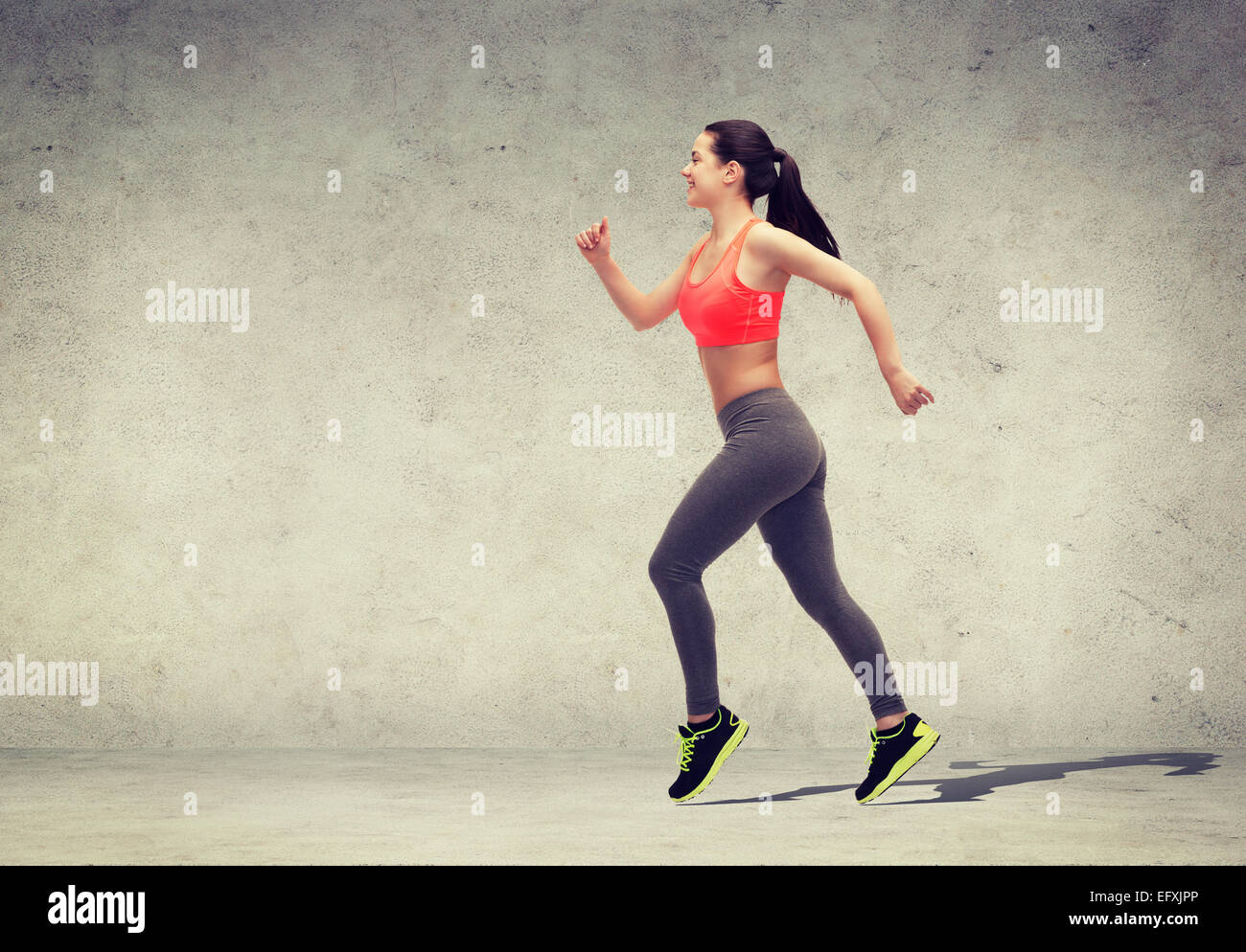 sporty woman running or jumping Stock Photo - Alamy