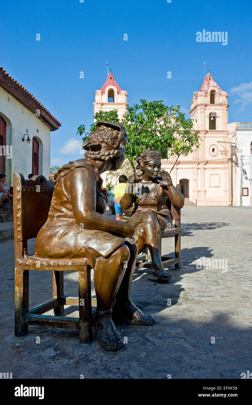 Vertical close up of lifelike comical bronze statues in Camaguey, Cuba ...