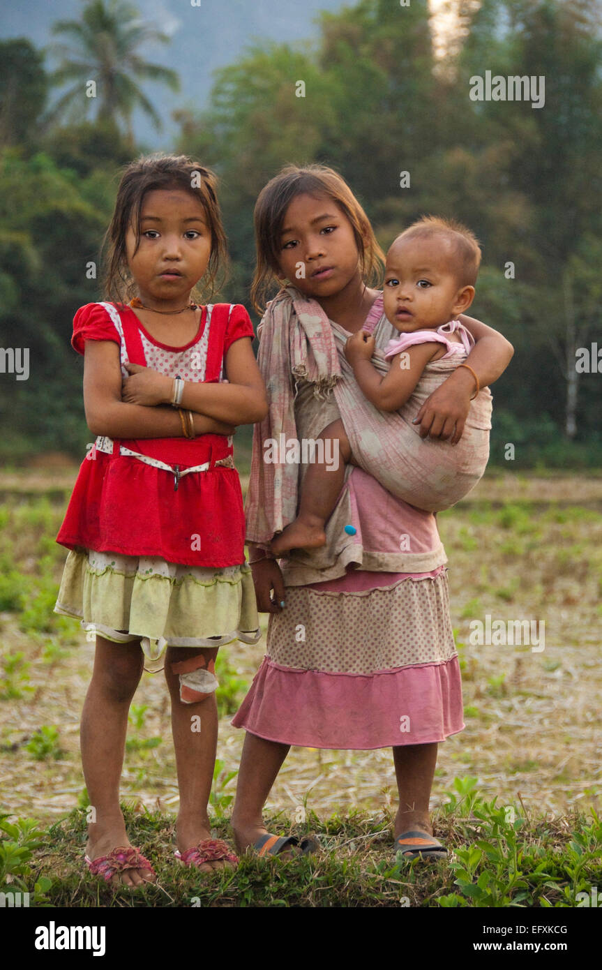 Vertical portrait of young Laotian children in the countryside ...
