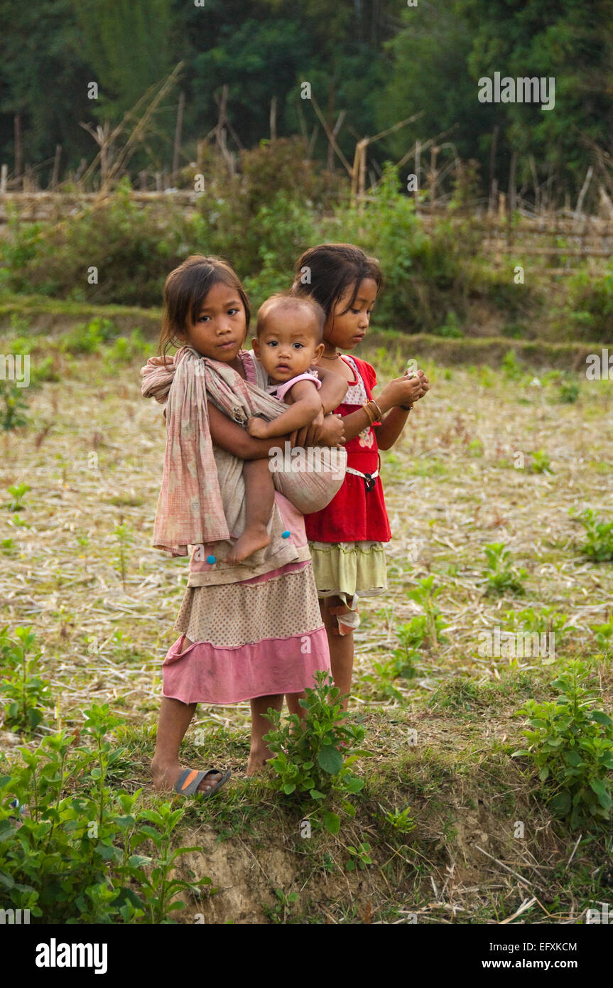 Vertical portrait of young Laotian children in the countryside ...