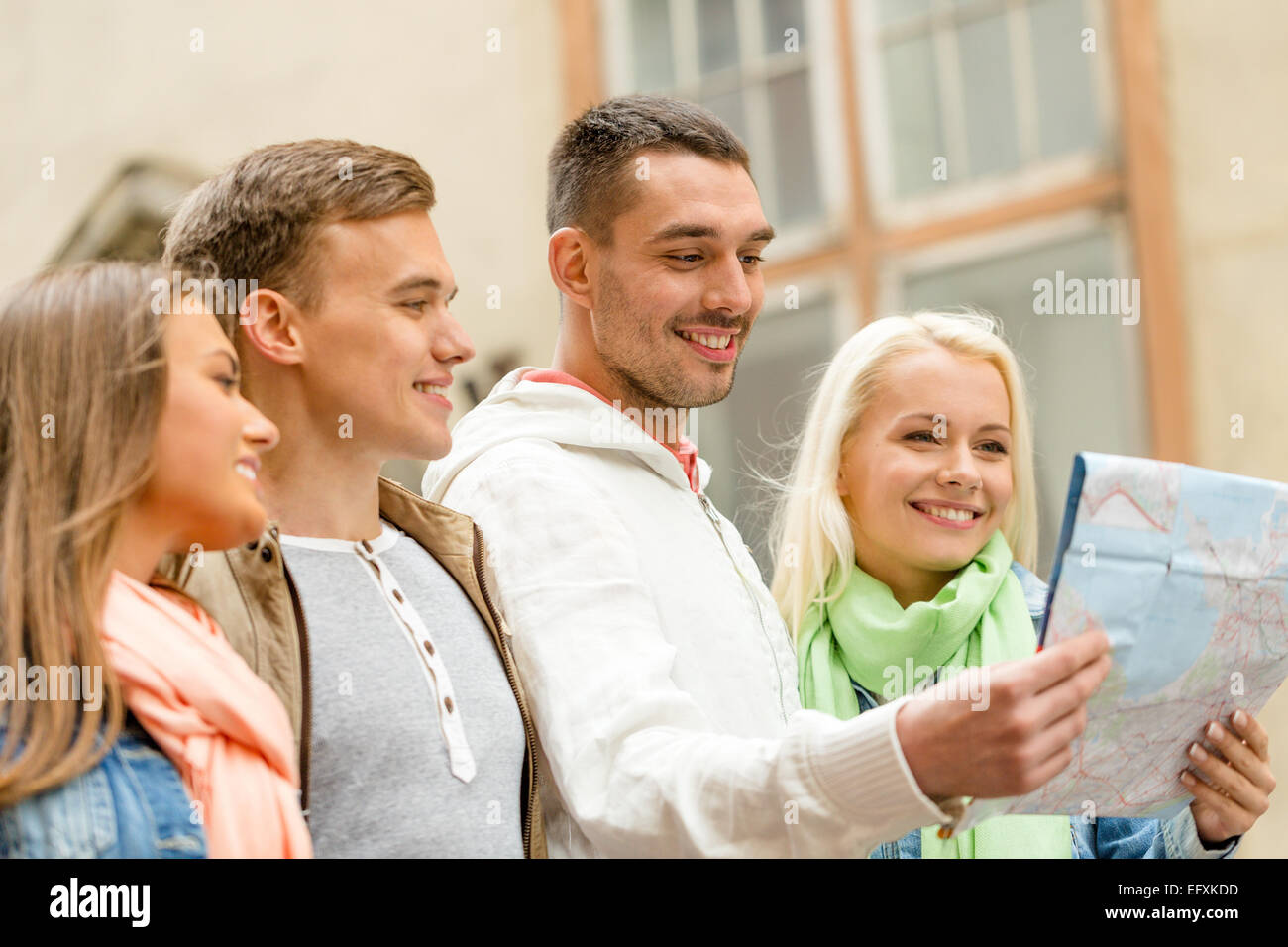 group of friends with map exploring city Stock Photo - Alamy