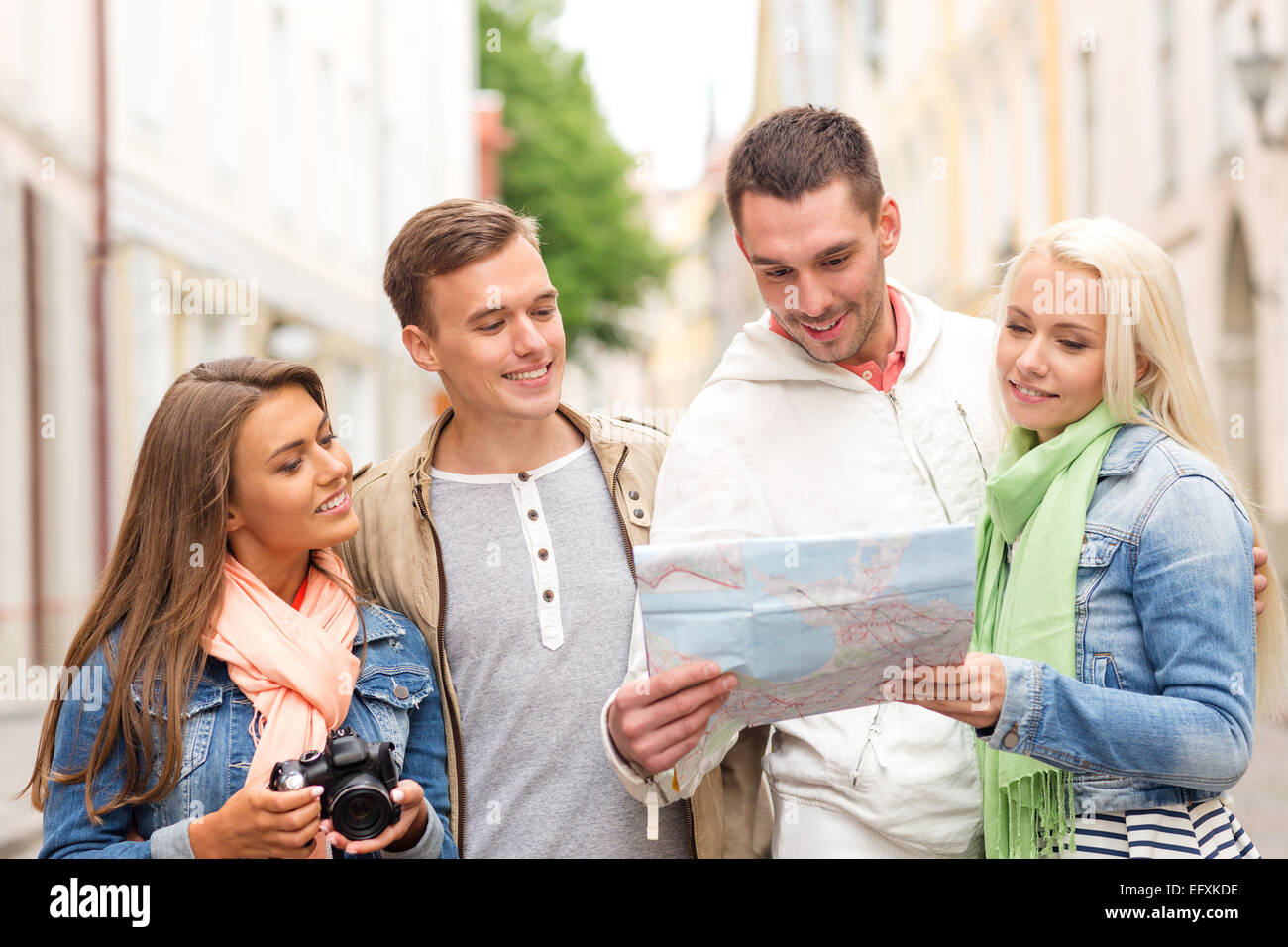 group of smiling friends with map and photocamera Stock Photo - Alamy