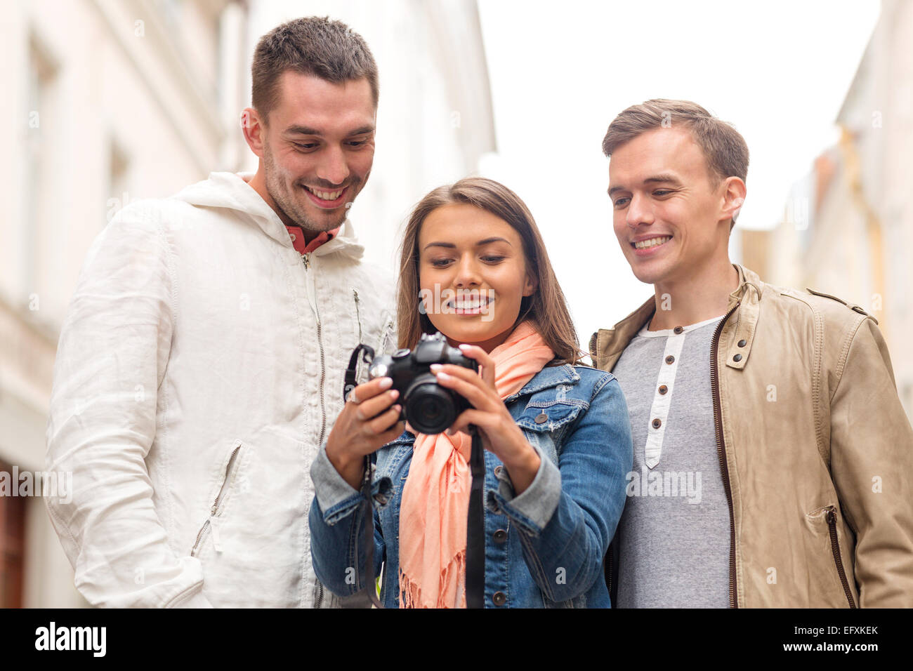 group of smiling friends with digital photocamera Stock Photo - Alamy