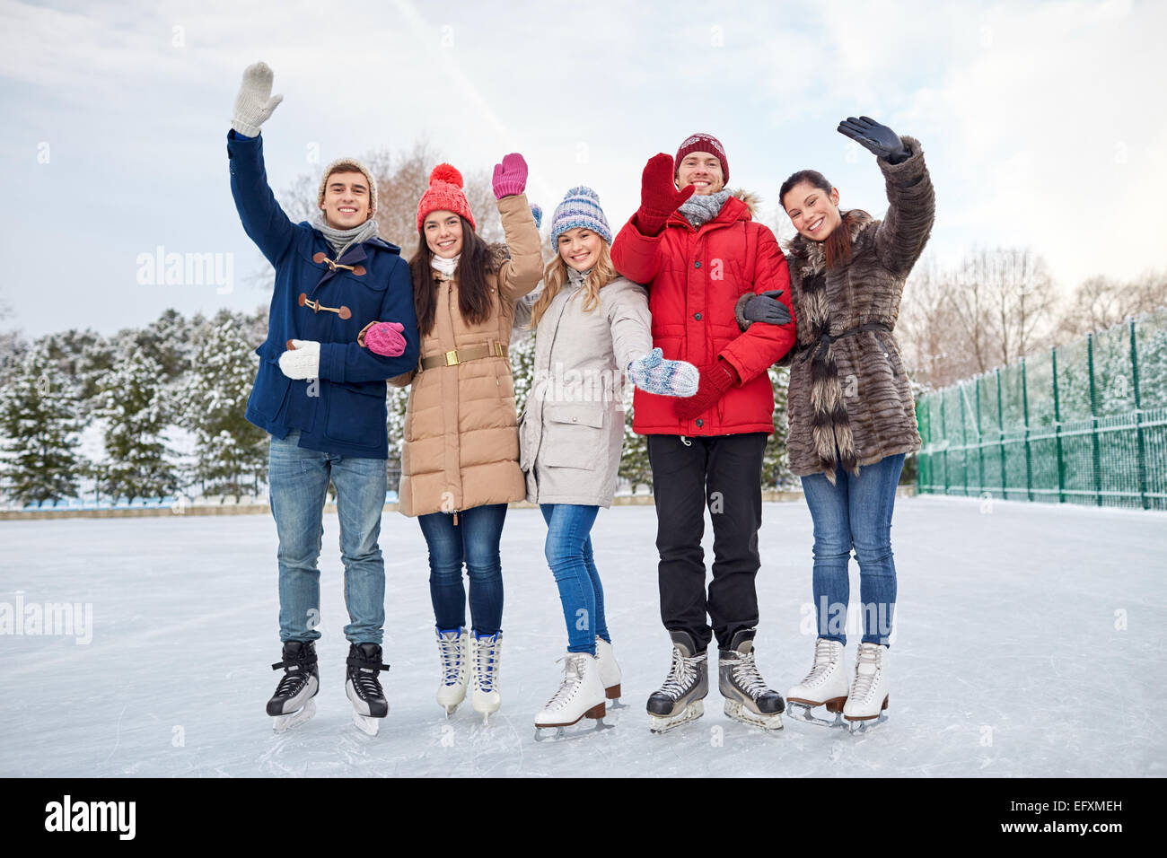happy friends ice skating on rink outdoors Stock Photo - Alamy