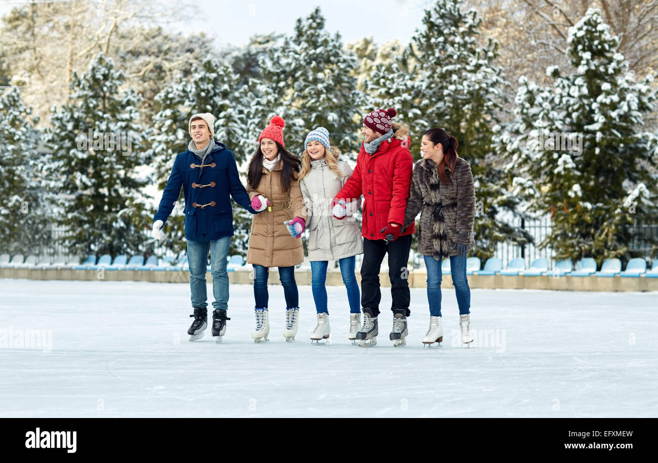 happy friends ice skating on rink outdoors Stock Photo - Alamy