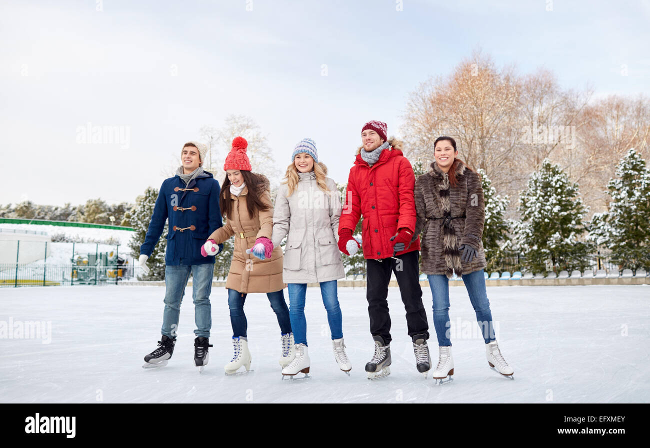happy friends ice skating on rink outdoors Stock Photo - Alamy