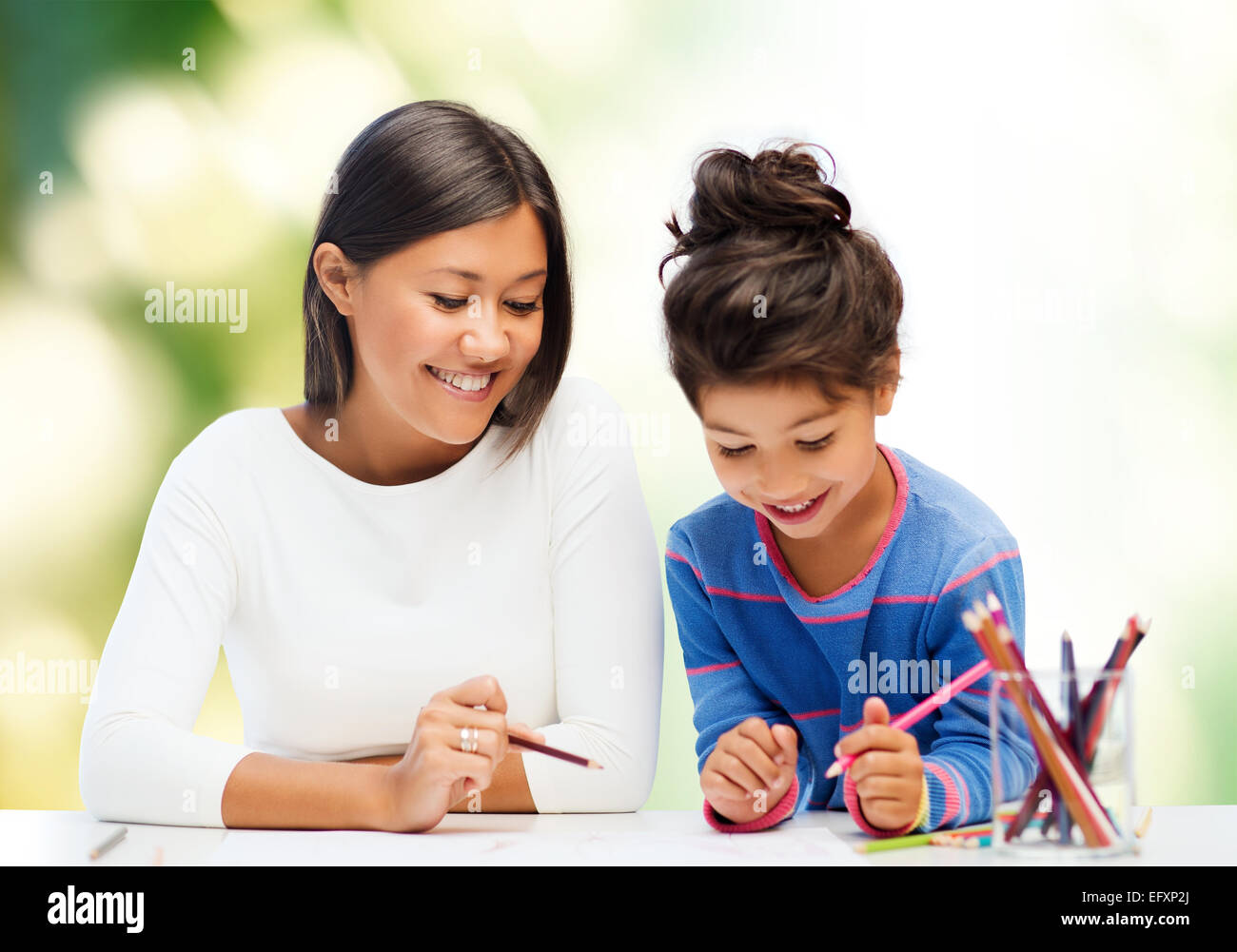 happy mother and daughter drawing with pencils Stock Photo - Alamy