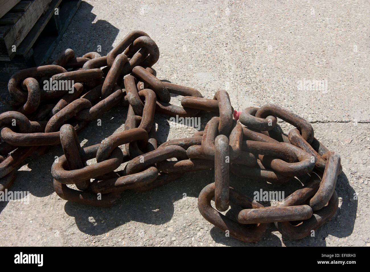 Iron chain on quayside Stock Photo - Alamy