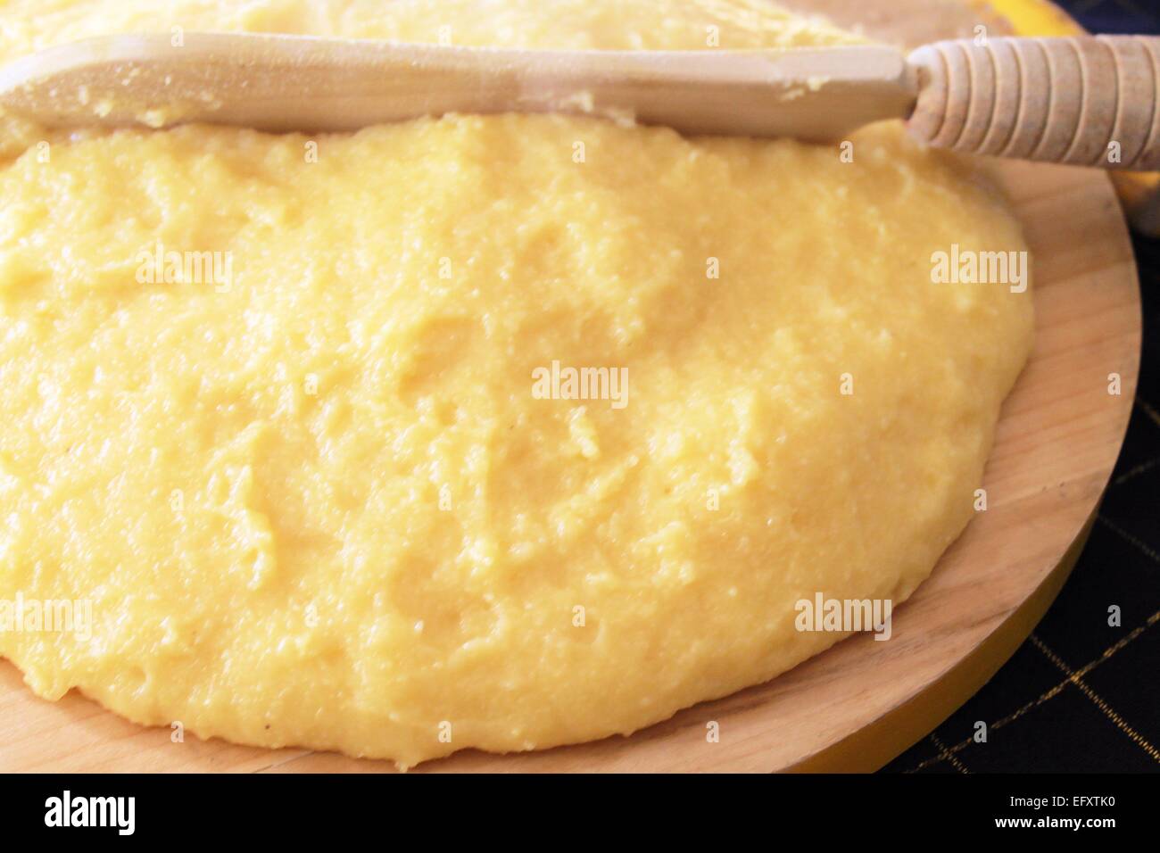 polenta, traditional dish of northern Italy on wooden cutting board ...