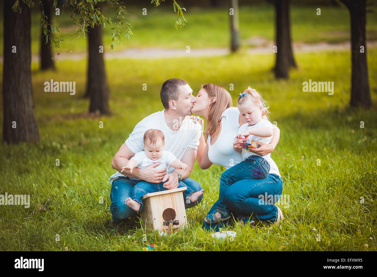 Happy family with nesting box and paints Stock Photo - Alamy