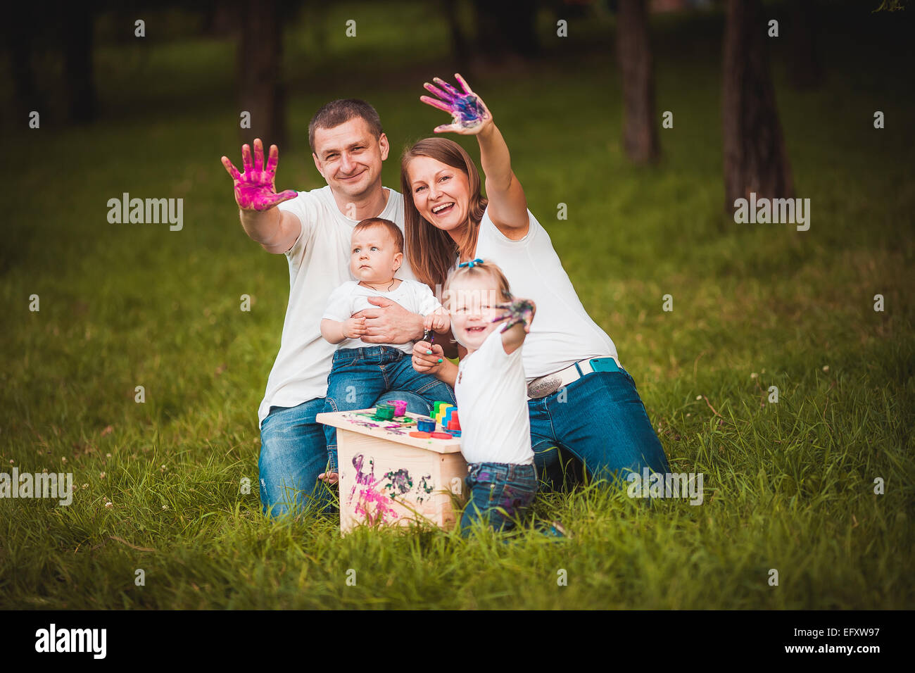 Happy family with nesting box and paints Stock Photo - Alamy