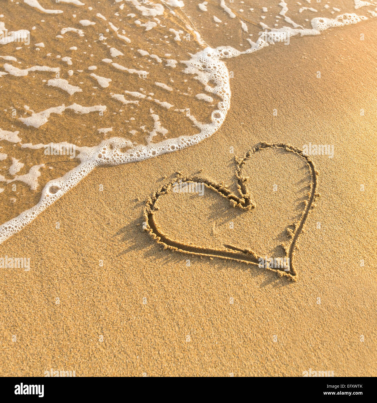 Hearts drawn in the sand hi-res stock photography and images - Alamy